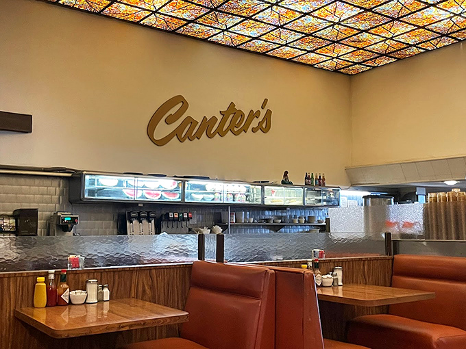 The stained-glass ceiling casts a warm glow over the dining room, creating an atmosphere that somehow manages to be both bustling and intimate.