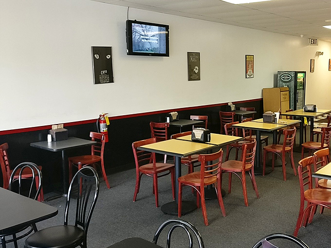 Red chairs and yellow tables create a diner palette that says, "We care more about your sandwich than our interior design budget."