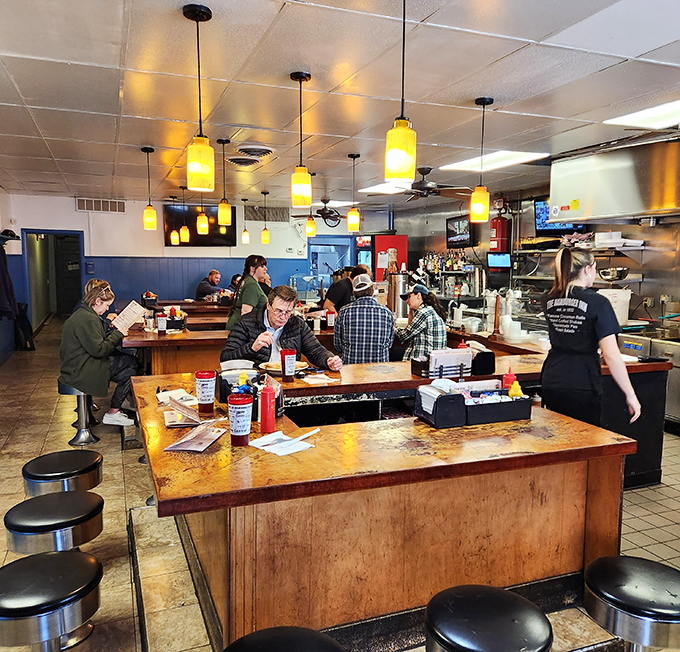 Yellow pendant lights cast a warm glow that makes everyone look like they're in a nostalgic indie film about finding yourself in small-town America.