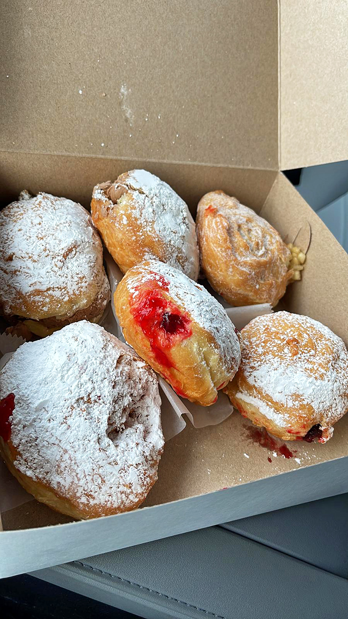 Powdered jelly donuts with that telltale red center&mdash;the pastry equivalent of a surprise plot twist you can actually see coming.
