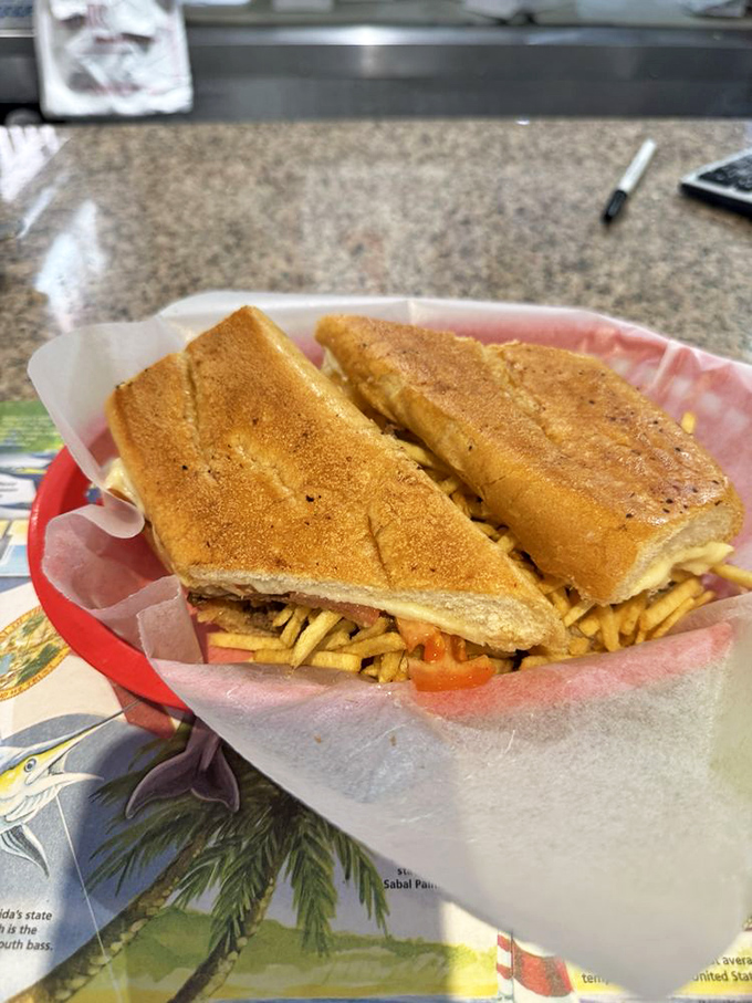 The Pan con Bistec &ndash; a sandwich that demands two hands and your full attention. Thin steak, crispy potato sticks, and bread that's both soft and crisp.