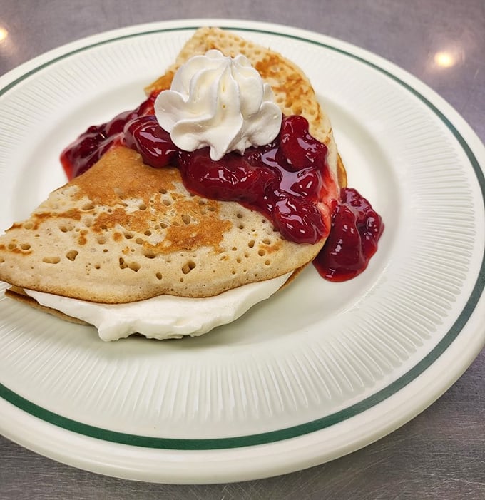 This isn't just a pancake&mdash;it's a fluffy canvas for berry compote and whipped cream. Breakfast or dessert? At diners, the line deliciously blurs. 