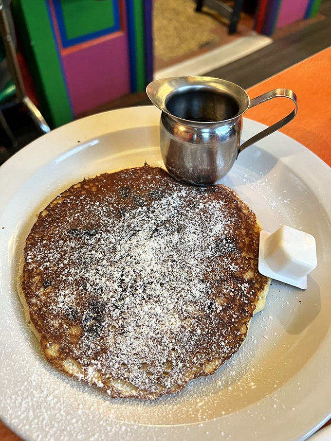 This pancake is so perfectly round and fluffy it looks like it's auditioning for a breakfast commercial. Powdered sugar snowfall included.