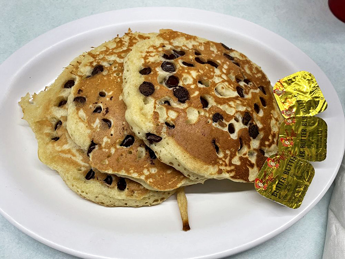 Chocolate chip pancakes that don't just satisfy hunger&mdash;they spark joy, especially with those little butter packets standing by like eager assistants.