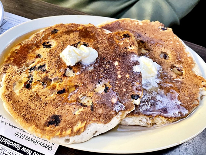 Pancakes so fluffy they might float away if not anchored by melting butter and what appears to be blueberry persuasion.