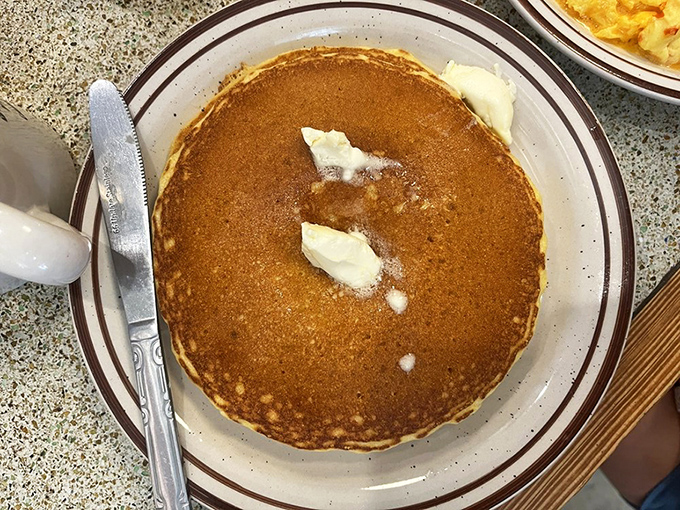 This isn't just a pancake&mdash;it's a golden canvas of possibility, waiting for you to create your own breakfast masterpiece with butter and syrup.