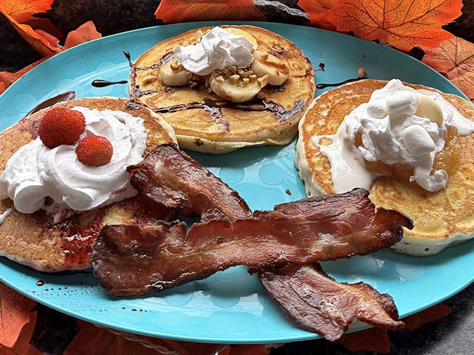 Pancake stacks that would make Paul Bunyan weep with joy, flanked by bacon so perfectly crisp it practically salutes when you pick it up.