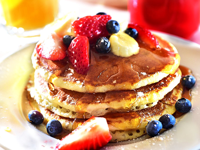Pancake perfection that makes you question every other stack you've ever encountered. Those berries aren't garnish &ndash; they're supporting actors in a breakfast blockbuster.