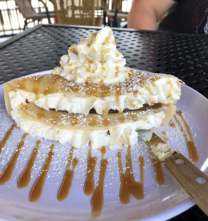 Layers of whipped cream, caramel, and crepe create the architectural wonder known as dessert. A sweet skyscraper worth every delicious floor.