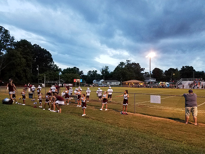 Friday night lights in small-town America, where cheerleaders practice routines and everyone knows someone on the field or in the stands.
