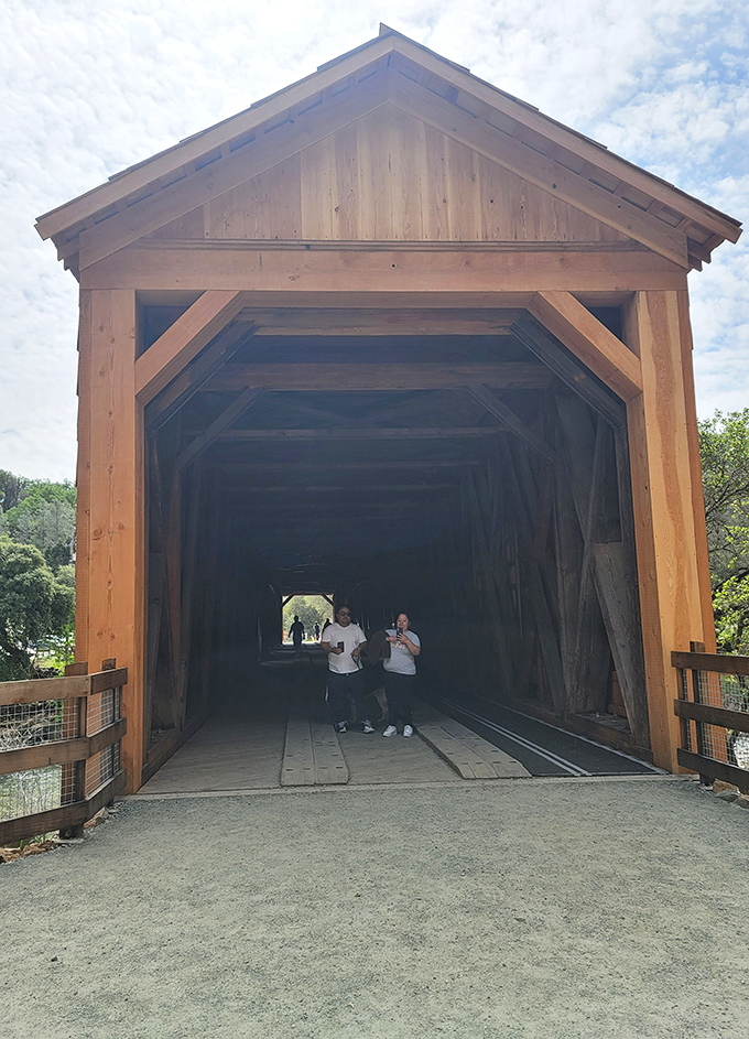 Inside the bridge, sunlight creates natural spotlights through the wooden lattice. No Instagram filter required for this authentic experience.