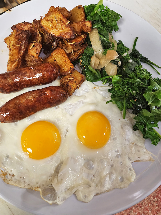 The breakfast platter that answers the eternal question: "Yes, you can have it all" &ndash; eggs, sausage, greens, and potatoes in perfect harmony.