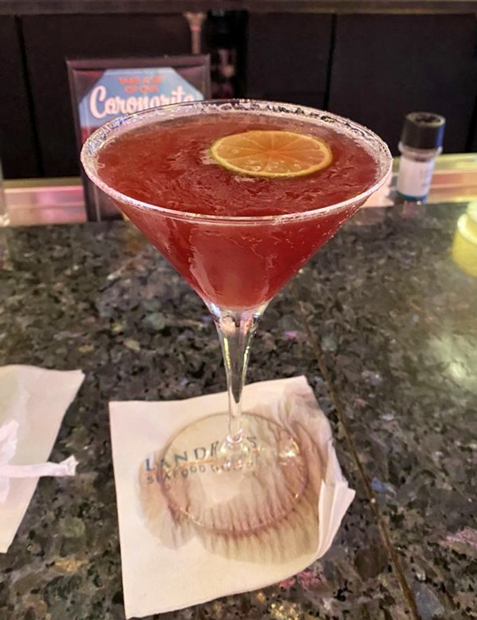 That ruby-red martini isn't just a drink&mdash;it's liquid entertainment with a citrus twist and a promise of good times ahead.