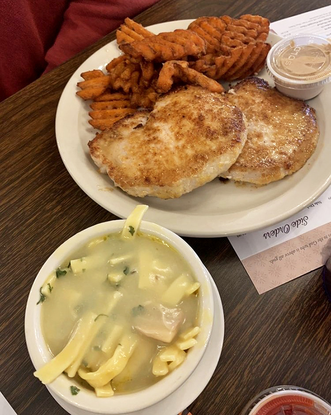 Comfort on a plate: golden pork chops, homestyle noodles, and sweet potato fries. The holy trinity of "I might need a nap after this."