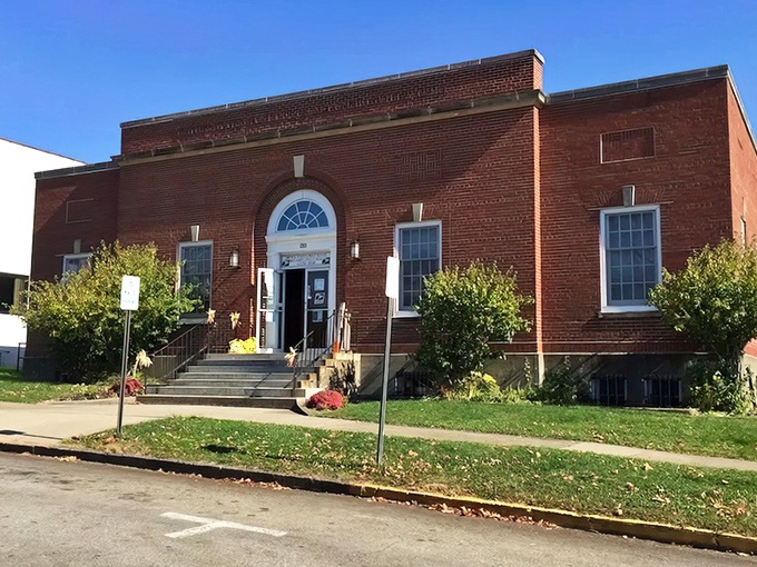 The brick Post Office building, with its arched entrance and tidy landscaping, serves as both a mail hub and an architectural gem.