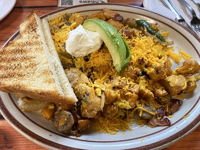 A mountain range of seasoned potatoes with melted cheese, avocado, and eggs &ndash; proof that breakfast is the most architecturally impressive meal of the day.