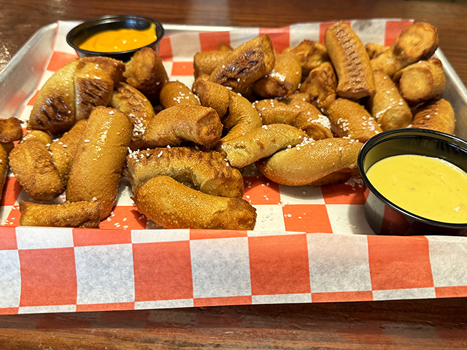 These pretzel bites aren't just appetizers – they're golden-brown pillows of joy, served with dipping sauces that demand double-dipping.