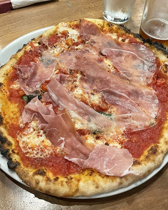 Prosciutto draped like silk scarves over a pizza canvas. This isn't just dinner &ndash; it's the food equivalent of a standing ovation.