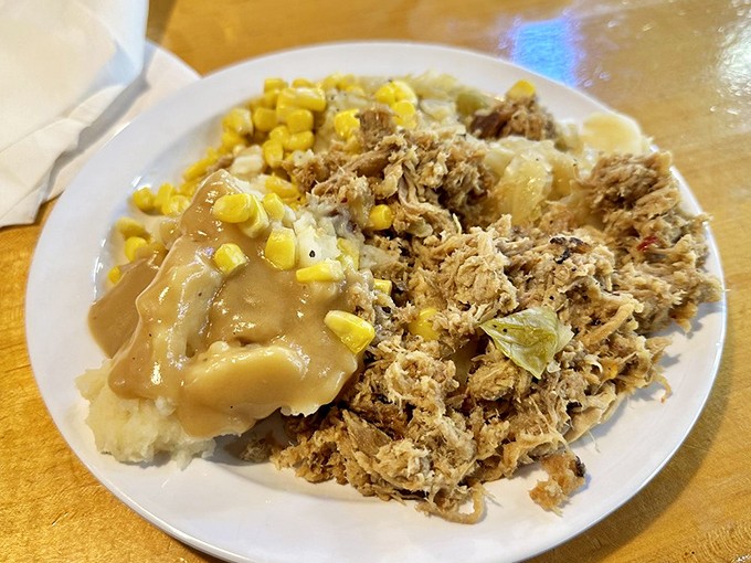 A plate that tells the South Carolina story better than any history book: pulled pork, mashed potatoes, and corn living in perfect harmony.