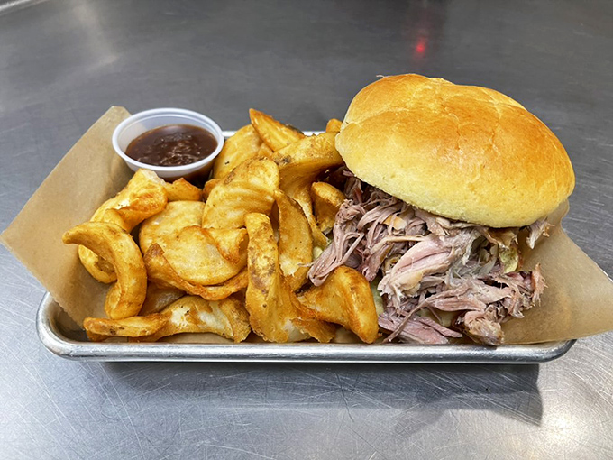 The pulled pork sandwich &ndash; a study in simplicity. Tender meat piled high on a soft bun with crispy potato wedges.