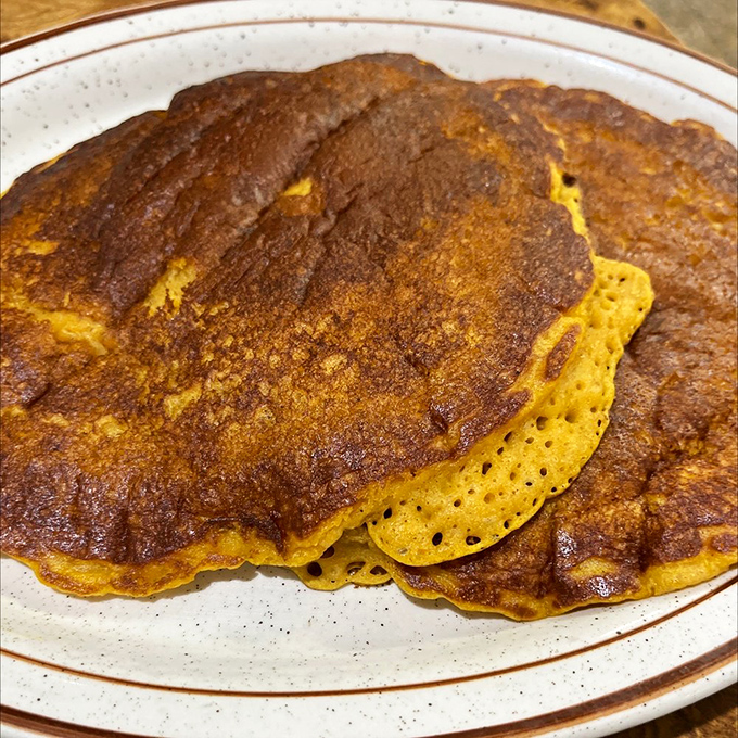 Pumpkin pancakes with that perfect amber hue and airy texture prove that Sulimay's griddle masters understand the delicate science of pancake perfection.