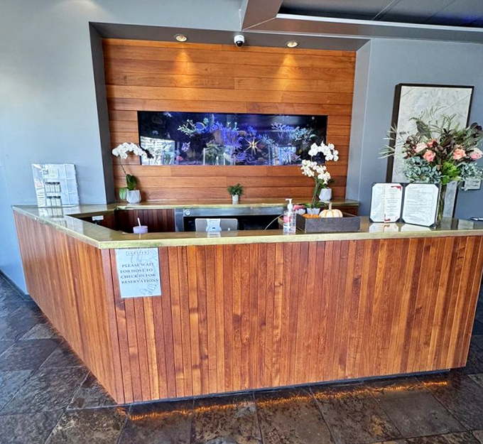 The reception area welcomes you like an old friend's beach house. Warm wood, clean lines, and the promise of ocean views beyond. 