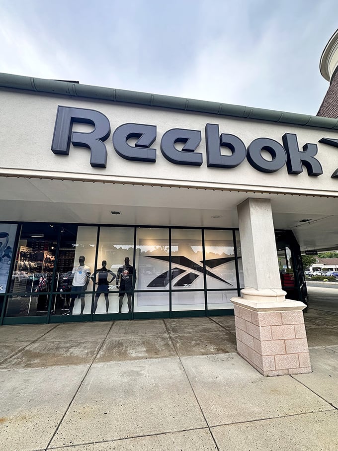 Reebok's window display showcases athletic aspirations. The mannequins never look winded after carrying shopping bags all day.