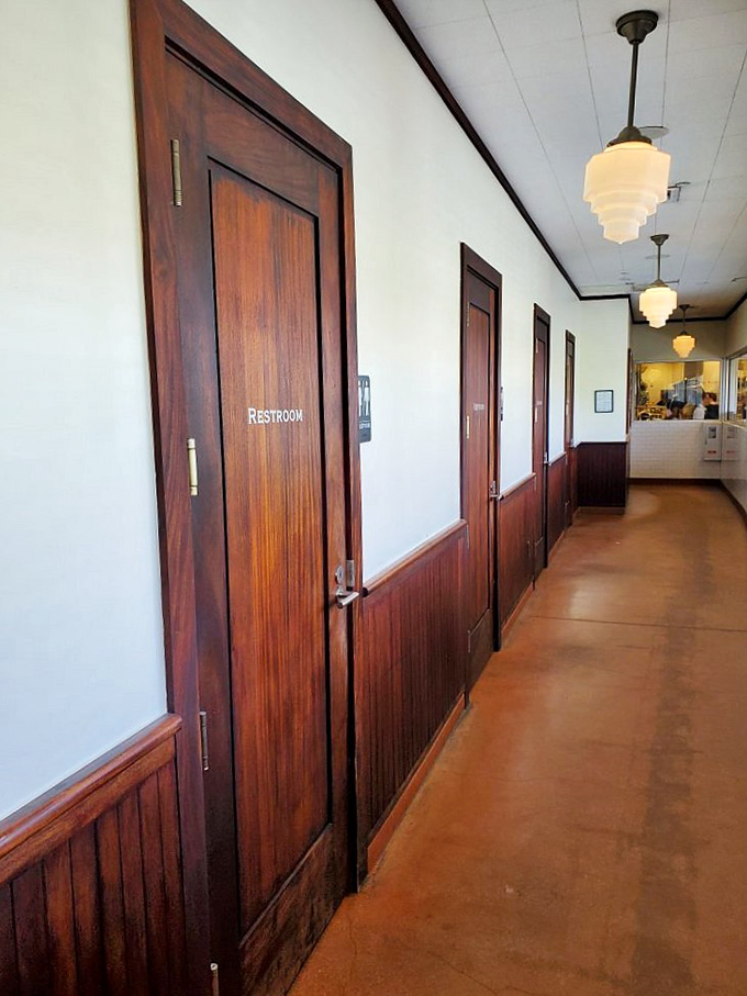 Even the hallway to the restrooms maintains the cafe's commitment to warm wood tones and vintage charm. No detail too small for thoughtful design.