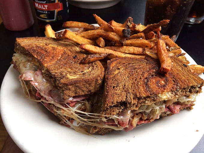 The towering Reuben sandwich stacked so high it defies gravity and common sense beautifully.