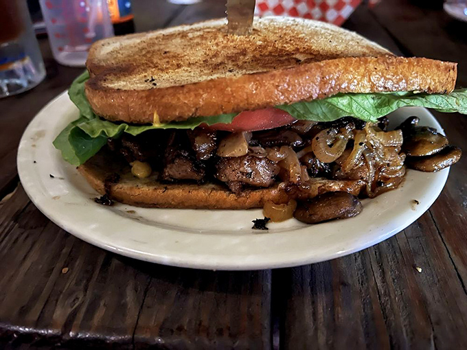 That sandwich isn't messing around—tender beef and sautéed mushrooms nestled between toasted bread with fresh greens for color (and conscience).
