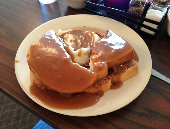 Hot roast beef sandwich swimming in gravy&mdash;proof that sometimes the most beautiful things in life aren't meant to be eaten daintily.