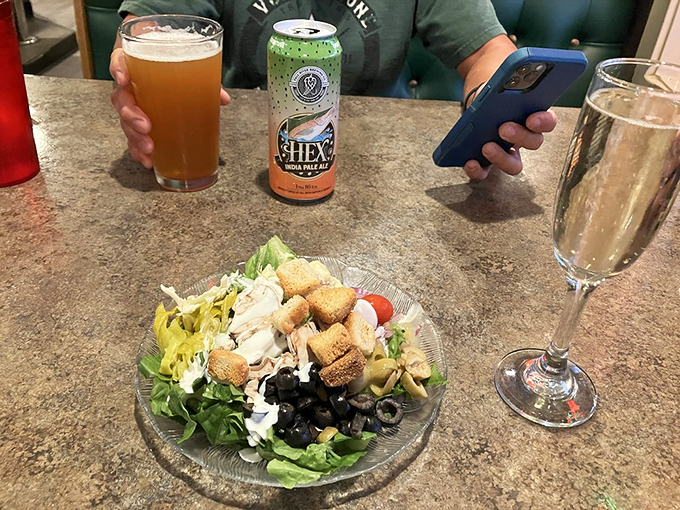 A salad that doesn't apologize for being a salad, enjoyed with local beer. Balance in all things, even road trip dining.