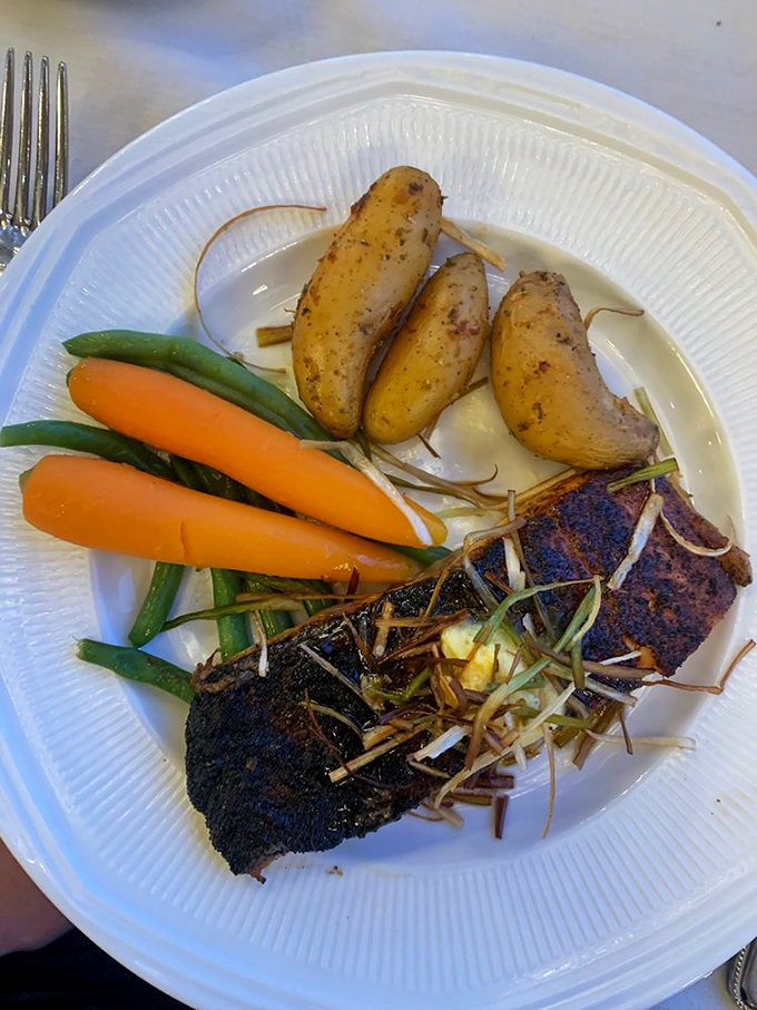 Salmon with vegetables so perfectly arranged they look like they're posing for a family portrait. Delicious formality.