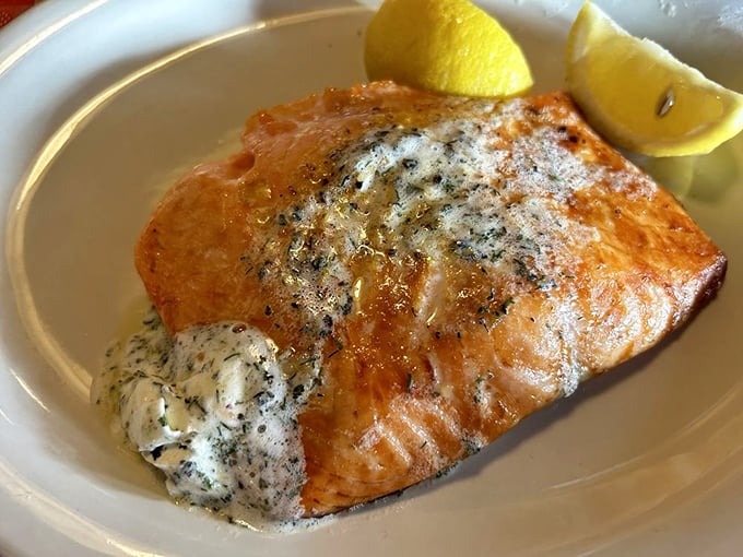 The salmon arrives perfectly cooked with a pat of herb butter slowly melting into a dish that proves Stroud's excellence extends beyond their famous chicken.