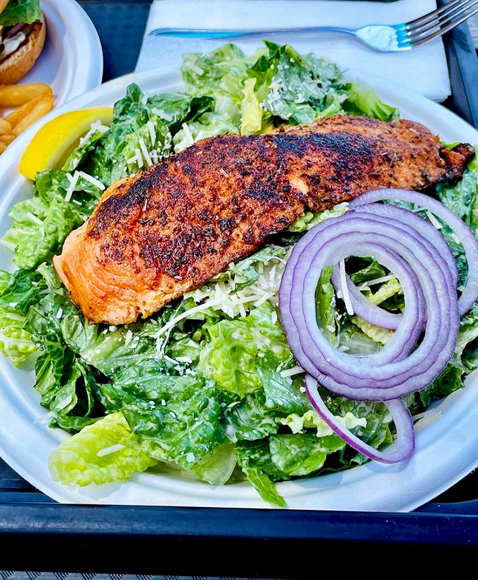A perfectly blackened salmon filet atop crisp romaine&mdash;proof that salads don't have to be punishment. This is the kind of lunch that makes you feel virtuous and indulged simultaneously.