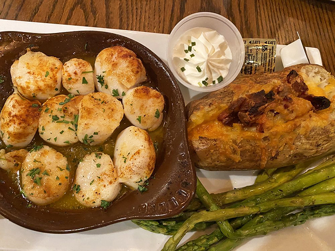 Sea scallops seared to caramelized perfection&mdash;ocean candy on a plate. That loaded baked potato is no slouch either.