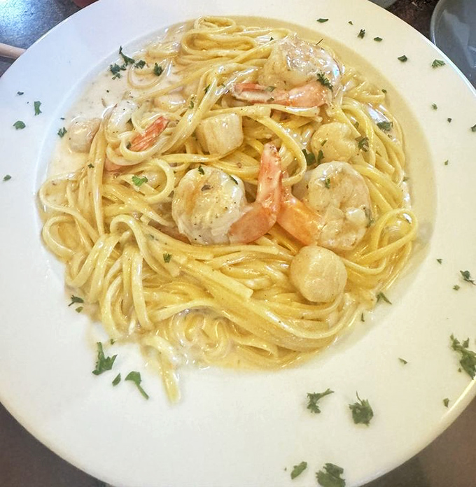 Seafood pasta that transports you straight to the Italian coast. Those plump shrimp swimming in creamy sauce prove that inland Pennsylvania can deliver oceanic delights.
