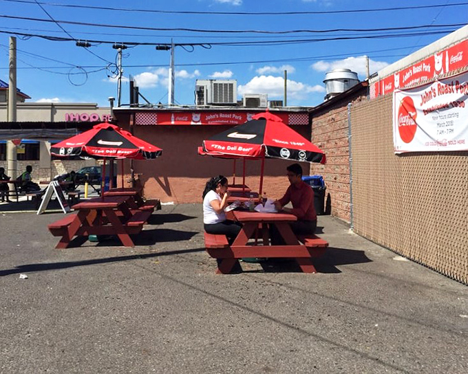 Red picnic tables under Coca-Cola umbrellas&mdash;where sandwich memories are made and diet plans go to die, gloriously and without regret.