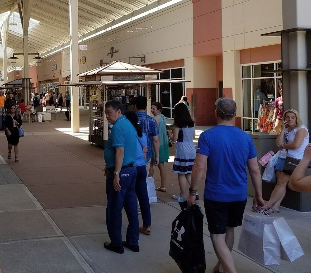 The universal shopping center shuffle: bags in hand, comfortable shoes on feet, and the determined look of people who've found bargains worth bragging about.