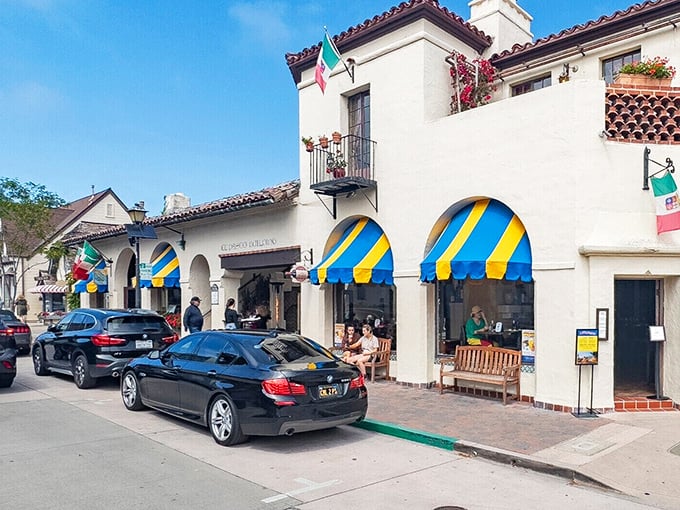 Blue and yellow awnings brighten the Spanish-style architecture, creating the perfect backdrop for an afternoon of boutique browsing.