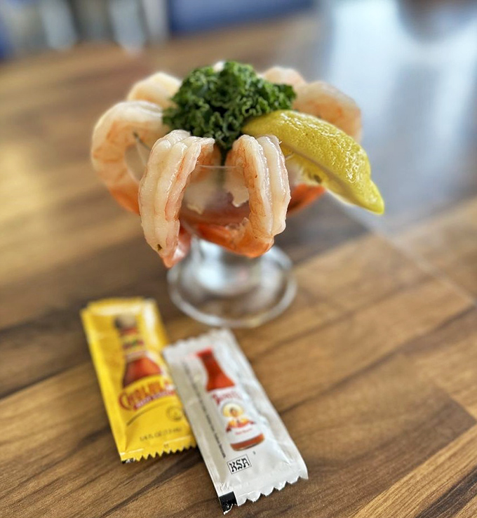 A shrimp cocktail that's dressed better than most people at fancy parties, complete with the condiment packets of champions.