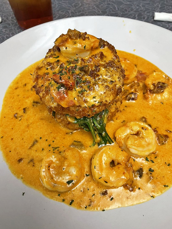 Shrimp and grits swimming in rich sauce prove Southern cuisine mastery extends beyond geography.