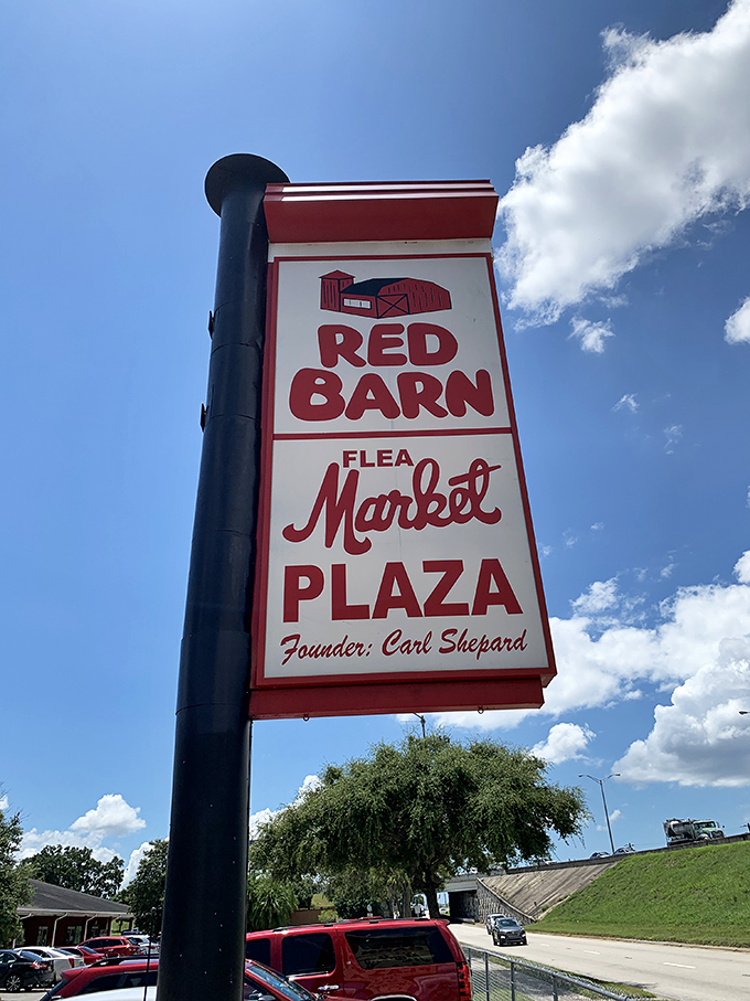 The iconic Red Barn sign stands tall against Florida's blue sky, a beacon for bargain hunters that's been drawing crowds for decades.