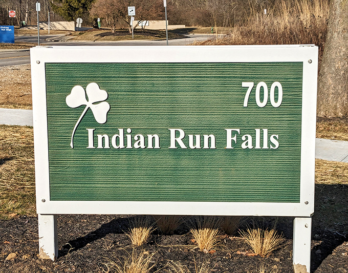 The entrance sign promises little, delivers much. That shamrock hints at the magical experience waiting just beyond the parking lot.