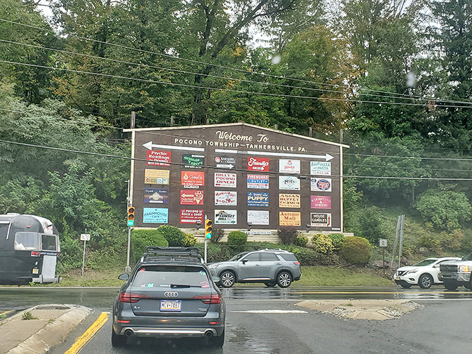 The "Welcome to Tannersville" sign serves as both invitation and warning: prepare your credit card for what lies ahead.