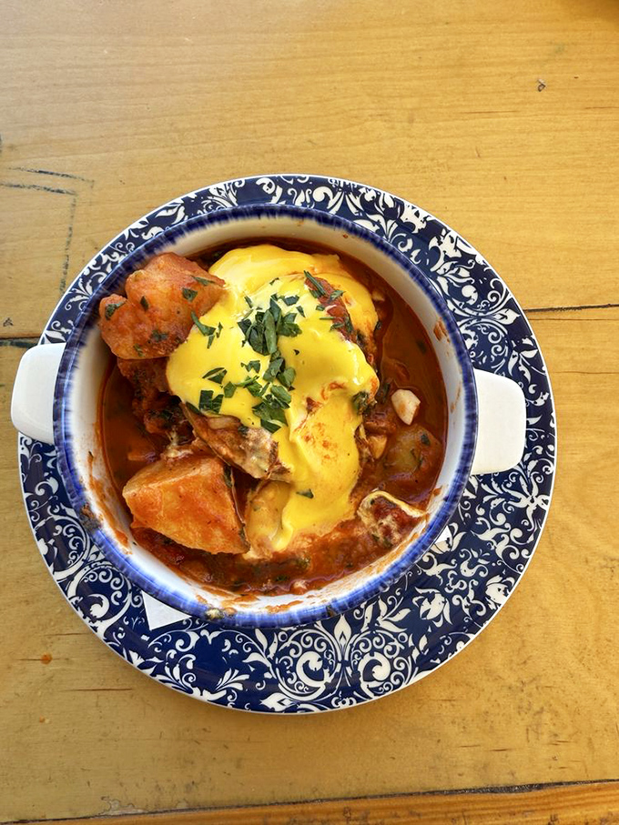 A hearty stew topped with melted cheese that says, "Bad day? Not anymore." Comfort food that hugs you from the inside out.