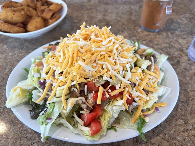 A salad that doesn't apologize for being delicious. That mountain of cheese is saying, "Yes, this still counts as eating your vegetables."