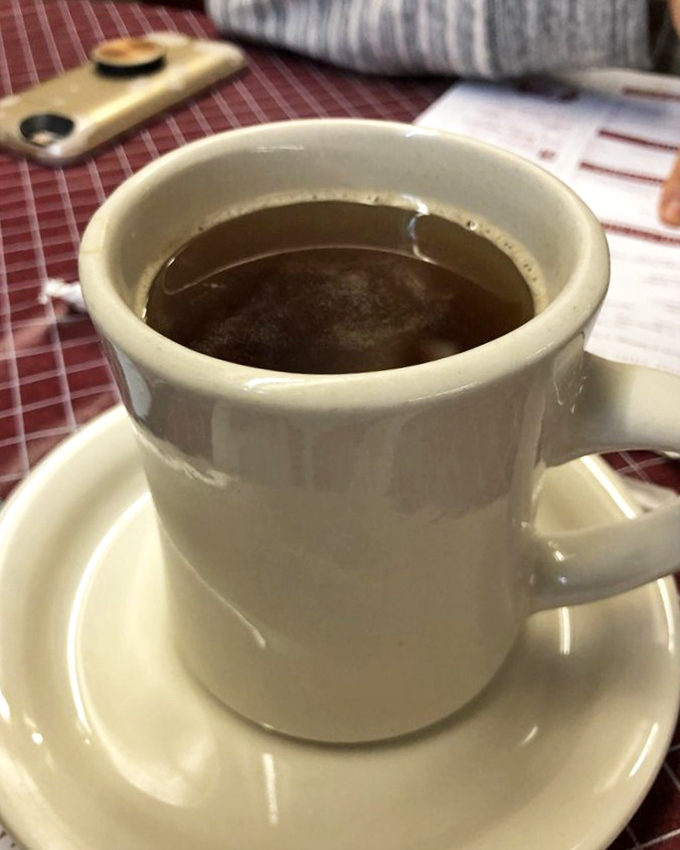 That's not just coffee—it's the elixir of small-town America, served in a sturdy mug that feels like it belongs in your hand.