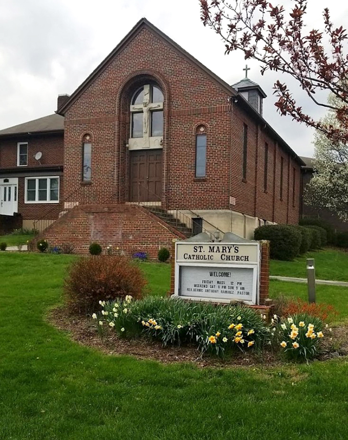 St. Mary's Catholic Church stands as a brick testament to faith, where daffodils bloom each spring regardless of economic forecasts.