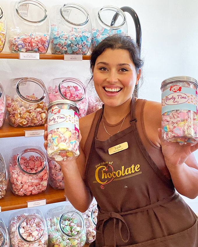 The joy of working surrounded by candy is written all over her face. Some people have jobs; others have paid sugar immersion therapy.
